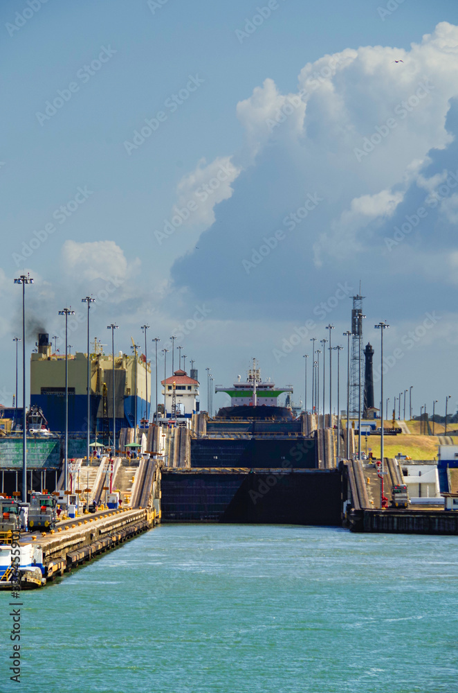 Cargo, container and tanker ships pass through Gatun Locks from Pacific ...