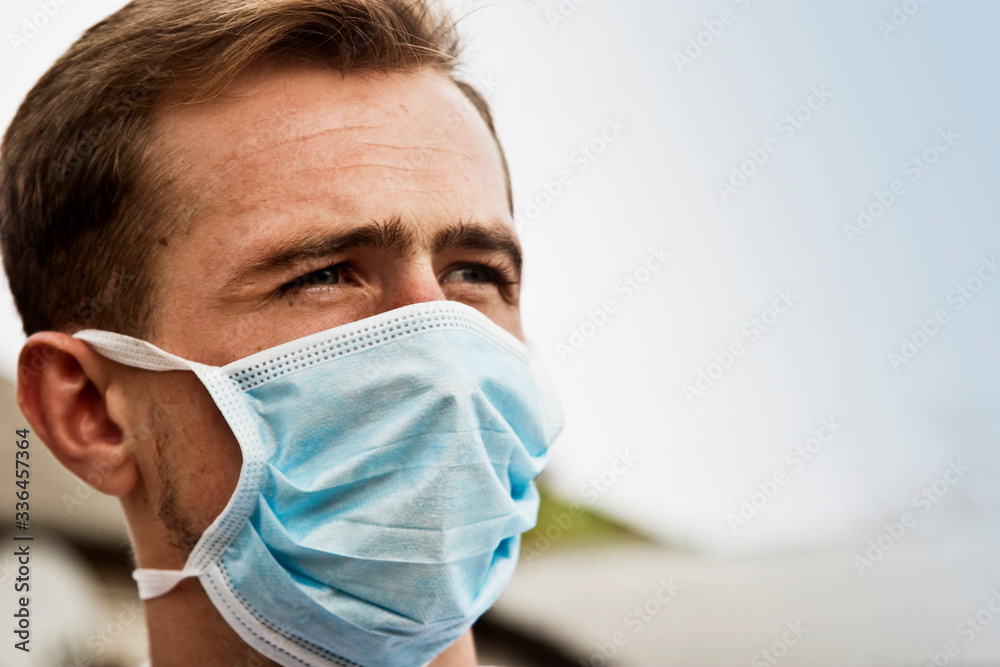 A guy in a medical mask close-up. The man covered his face with a mask ...