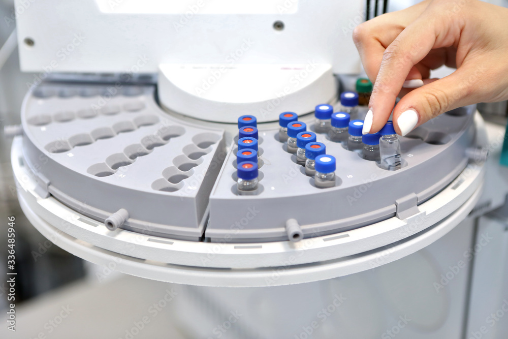 Quality Control Laboratory medicine. Chromatograph operation. A woman ...