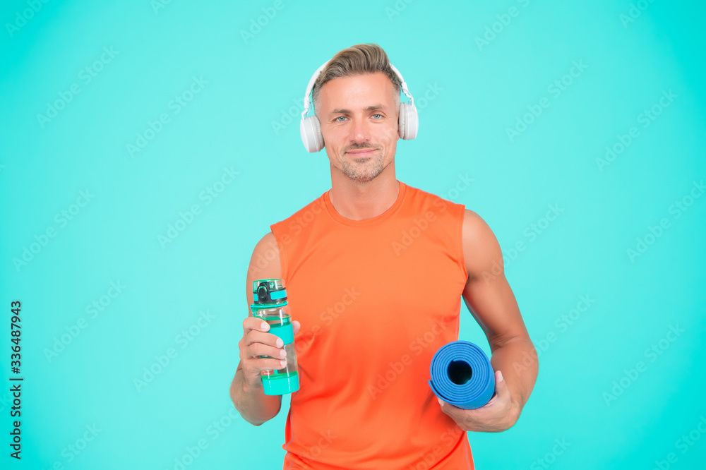 Hydration for athletes. Fit athlete gold water bottle blue background ...