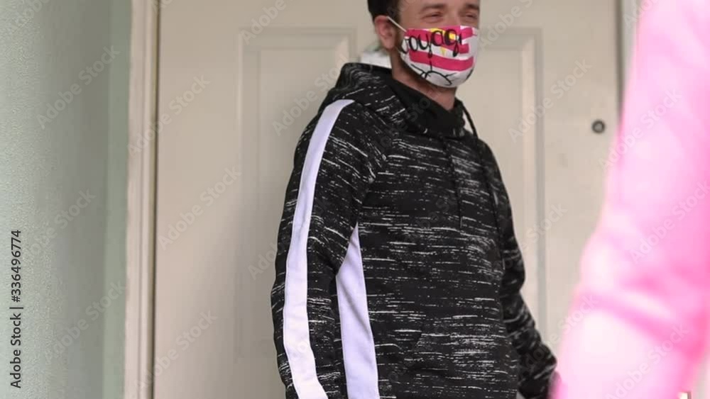 Family exiting their house to go outside wearing face masks. Covering ...
