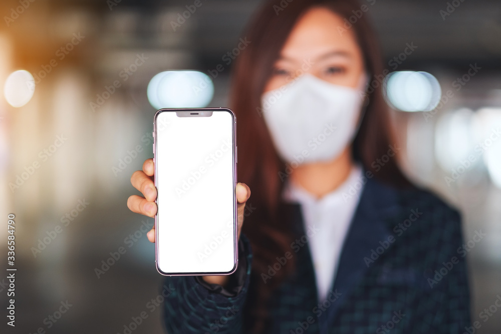 Mockup image of a woman wearing protective face mask, showing mobile ...