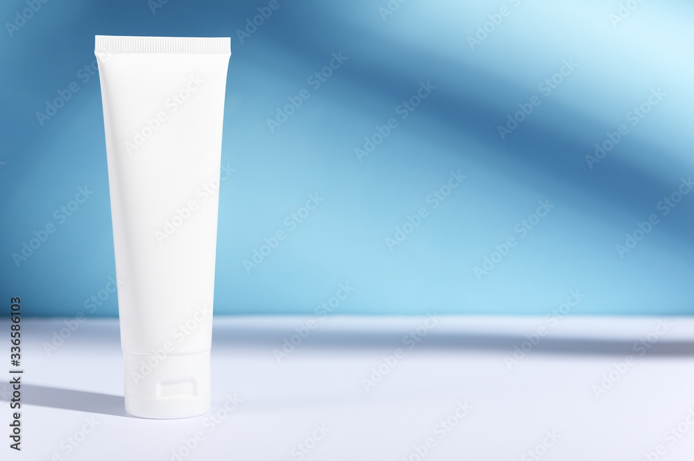 Feminine hygienic product tube on sunny blue background with shadow ...