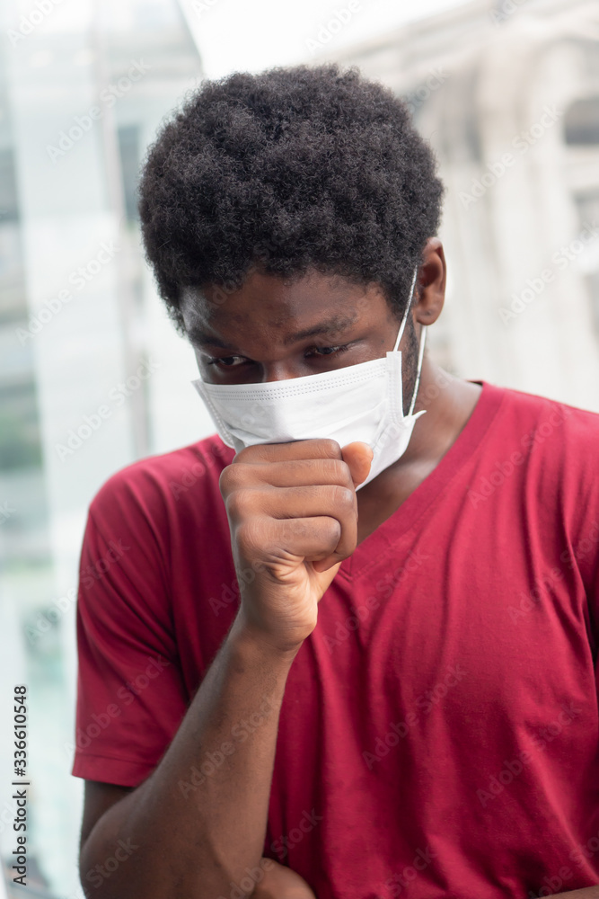 allergic sick black African man coughing with sore throat; concept of ...
