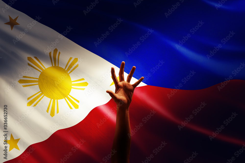 a raising hand in front of Philippines flag, idea, conceptual images ...