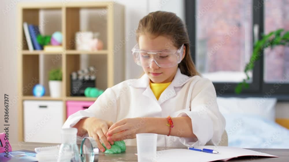 science, childhood and chemistry concept - girl in goggles playing with ...