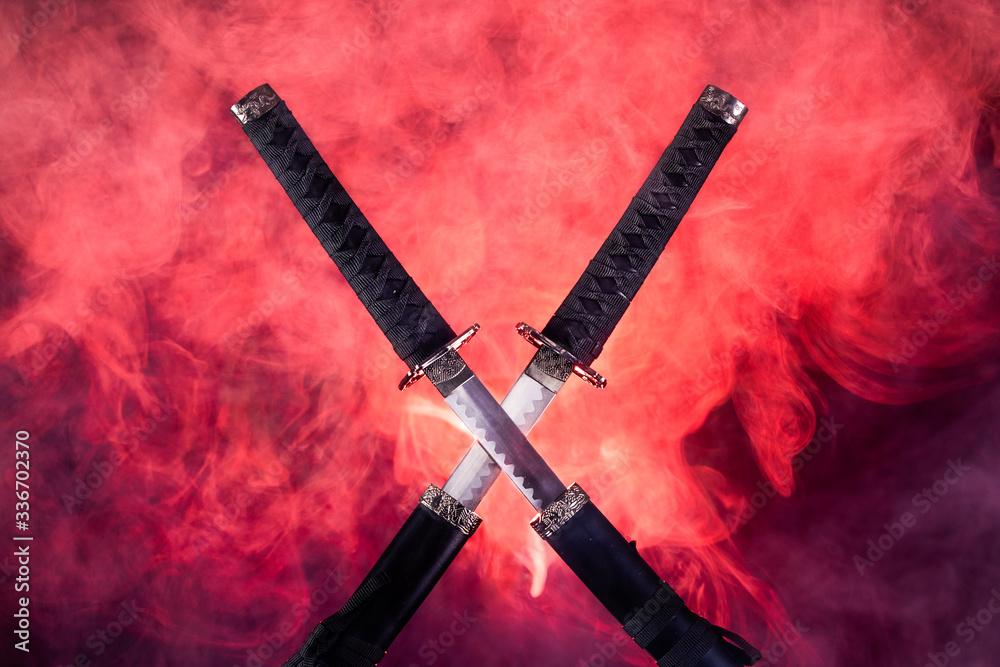 Photo Partially drawn blades of two katanas in red smoke, Vit Kovalcik ...