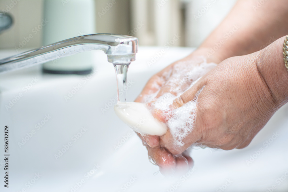 Washing hands with soap under the faucet with water. Coronavirus ...
