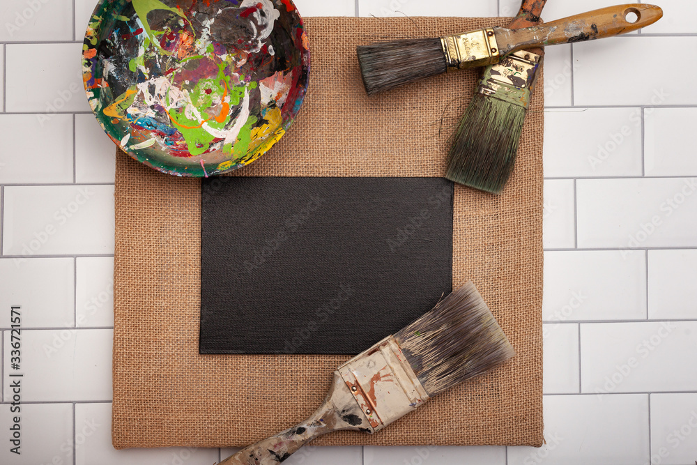 Blank empty black canvas ready to add text three paintbrushes framing ...