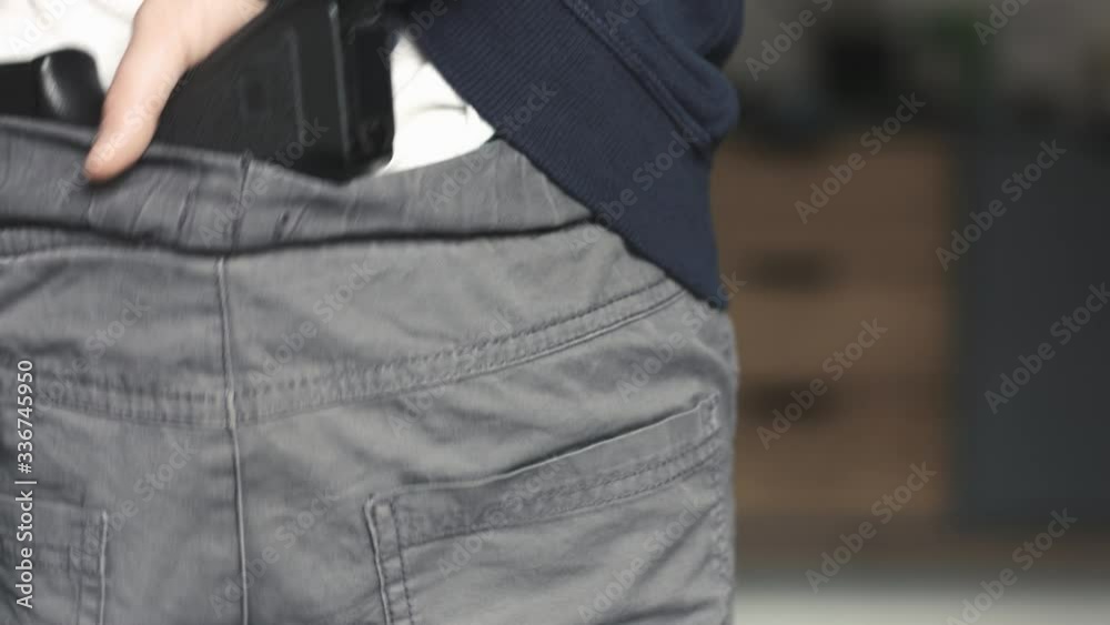 Close up of a young boy pulling out a nine millimeter toy gun perfect ...