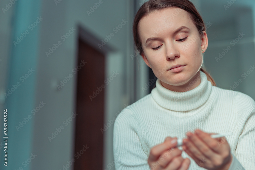 European woman checking high temperature with thermometer. Corona virus ...