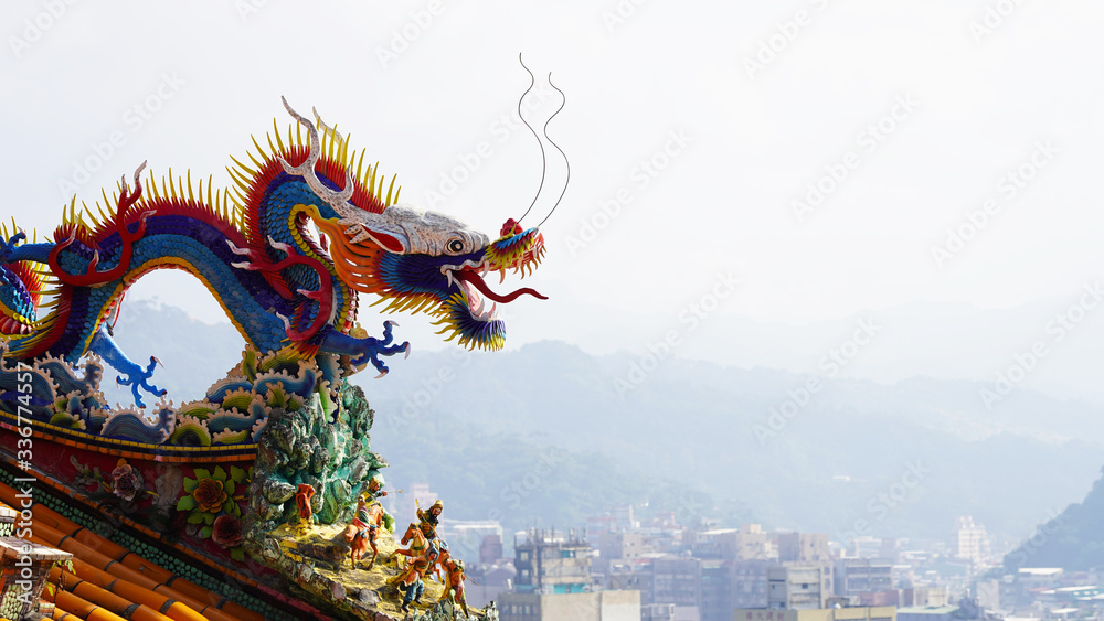 bright multi-colored sculptures of Japanese samurai dragons on the roof ...