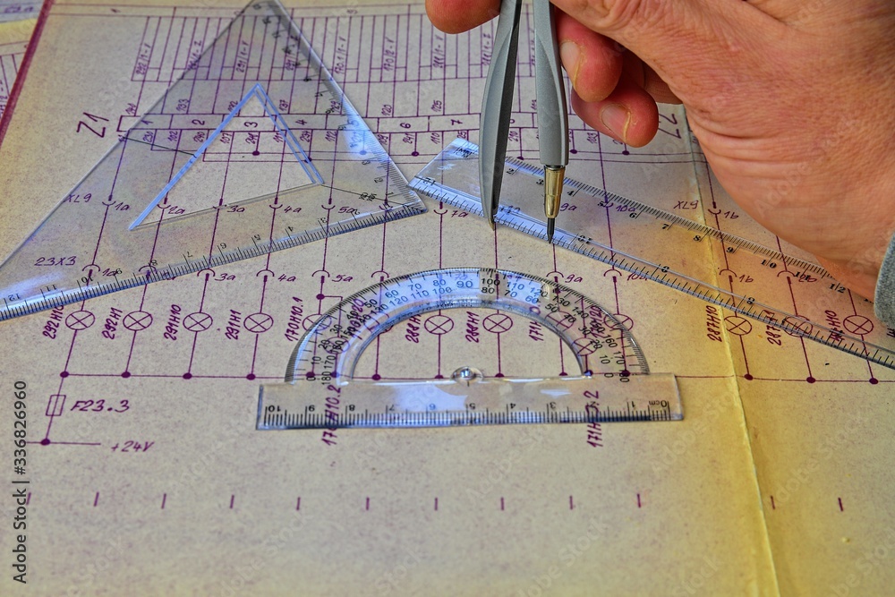 Electrical engineer workplace - electrotechnical project, rulers, and ...