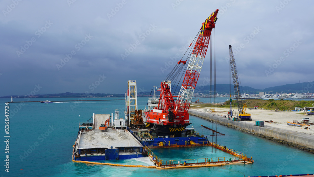 Floating crane platform with a huge bucket extracts sand from the ...