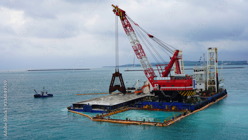 floating crane platform with a huge bucket extracts sand from the ...
