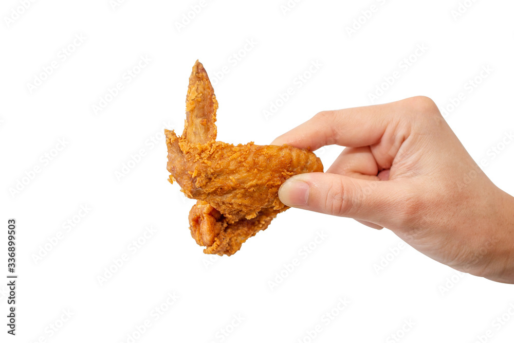 Hand holding fried chicken wing. Stock Photo | Adobe Stock