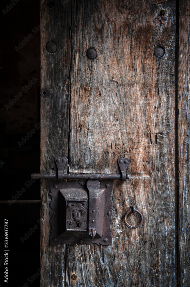 Ancient rusty steel lock bolt with a key hole installed on an old ...