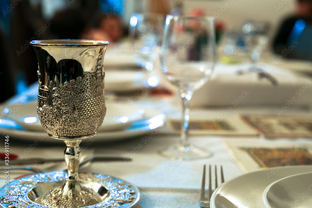 table bound for a traditional Passover seder with a cup of Elijah the ...