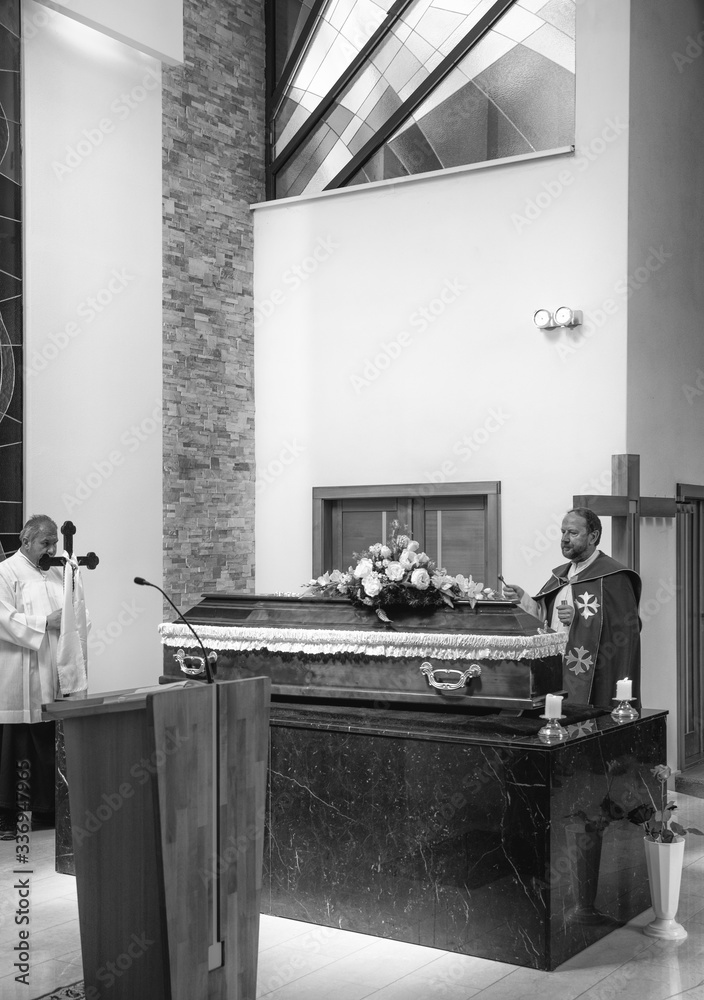 Priest and coffin during funeral ceremony Stock Photo | Adobe Stock