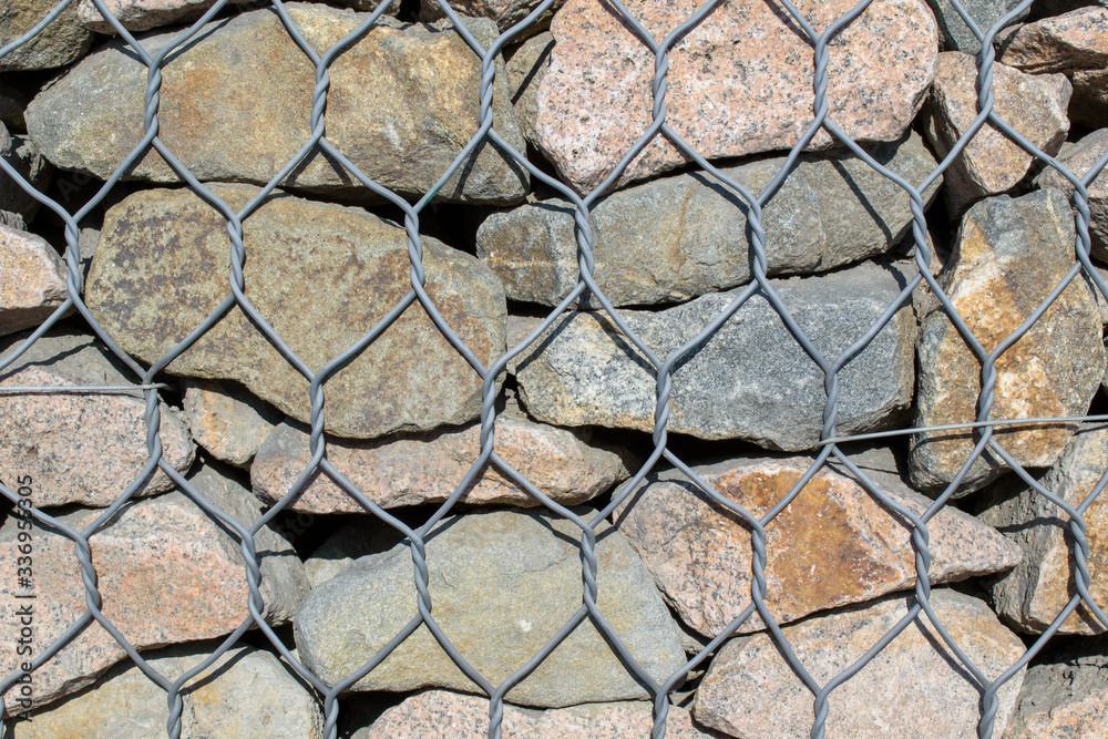 Stainless steel wire mesh. Big rocks. Concept of gabion designs for ...