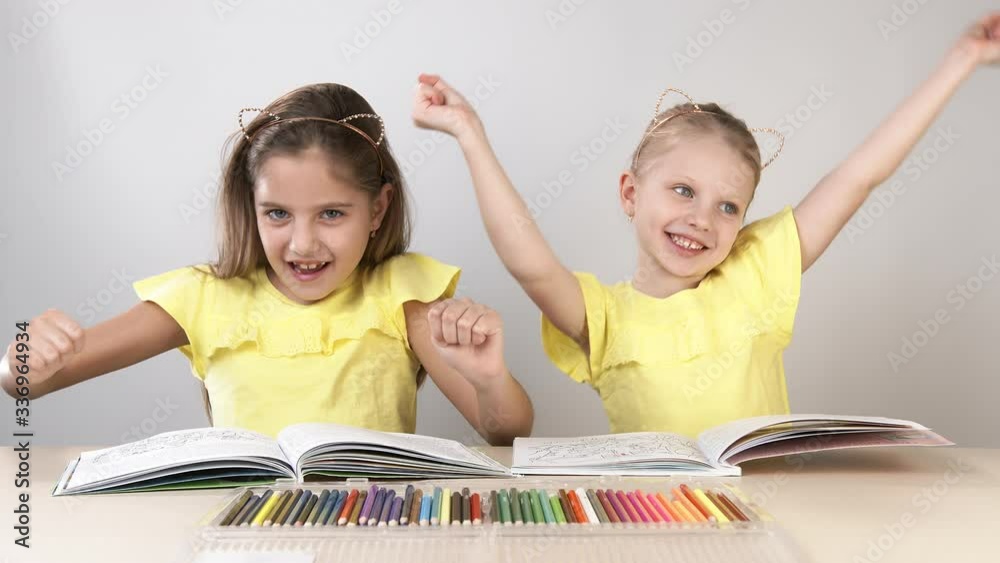 Funny and funny children. Children at the table dance and create. Two ...