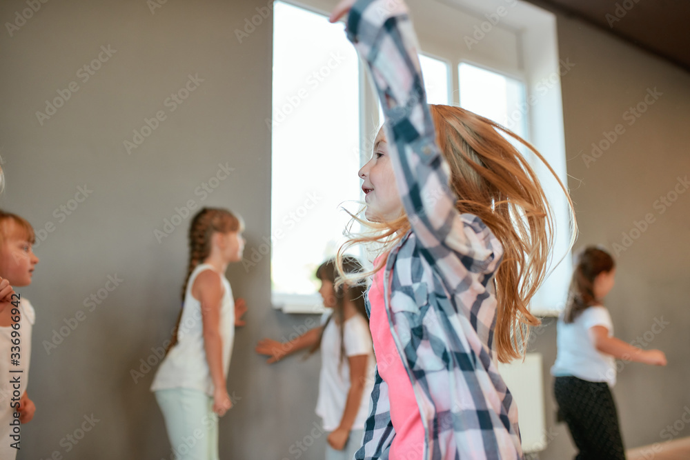Healthy lifestyle. Portrait of a little happy girl dancing and having ...