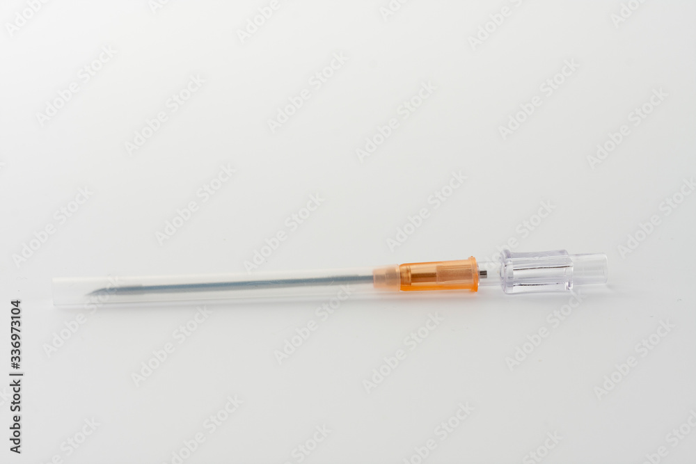 Orange intravenous cannula 14 G on white background, external diameter ...