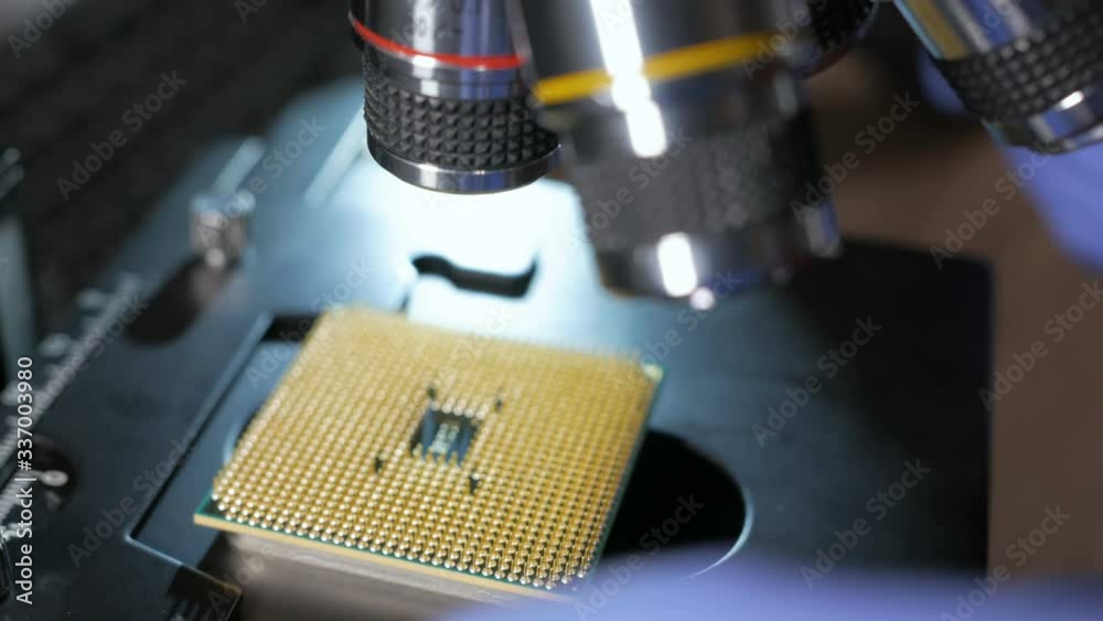 Processor is being examined for apparent defects under microscope. In ...