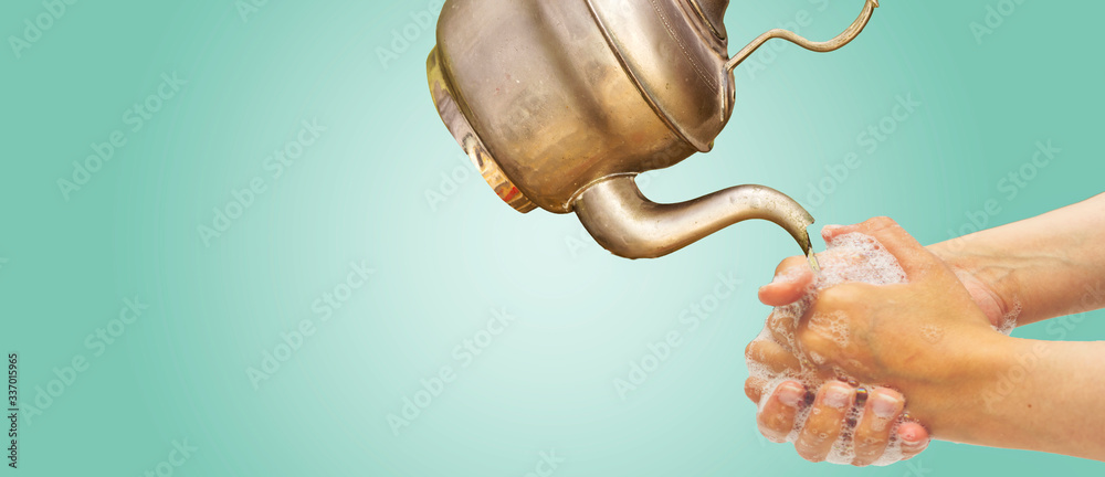 arabic woman washing hands with soap and using copper jug water for ...