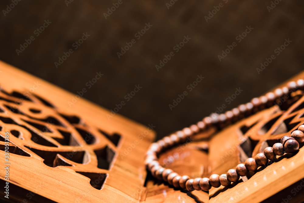 Islamic prayer beads or tasbih on rihal or quran book stand made from ...