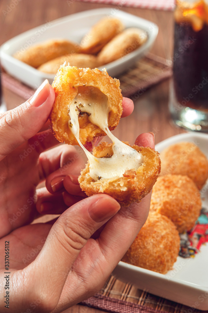 Brazilian appetizer deep fried cheese croquette in closeup - Bolinha de ...