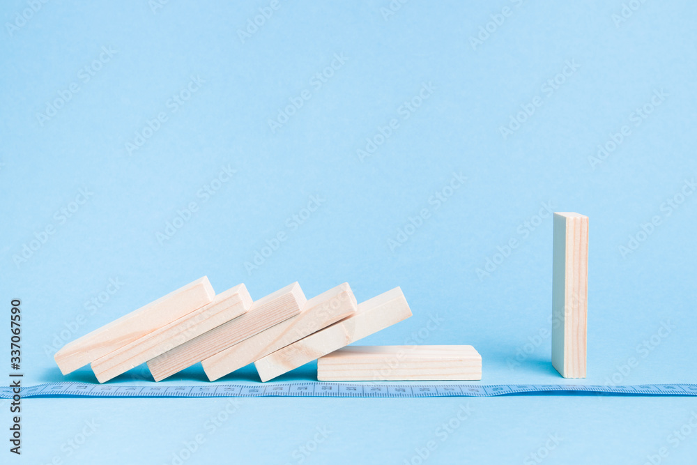 wooden square dominoes lie in a row on a blue background, one block ...