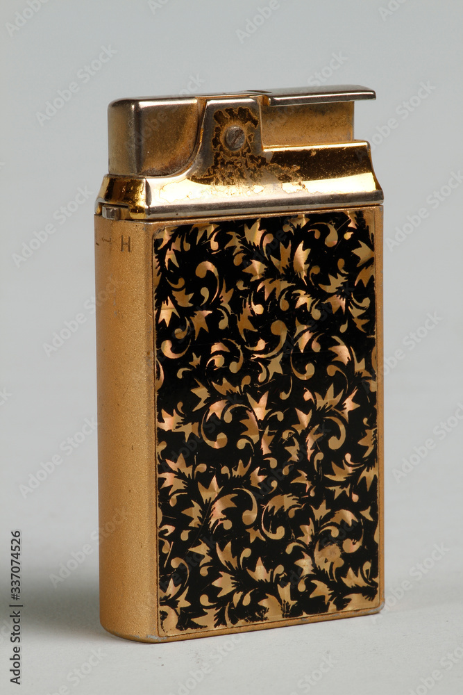 Open old lighter in red and beige cap. Lighter with a brand or logo can ...