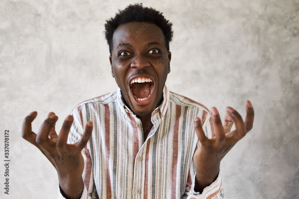 Frustration, anger and rage concept. Enraged furious young African ...