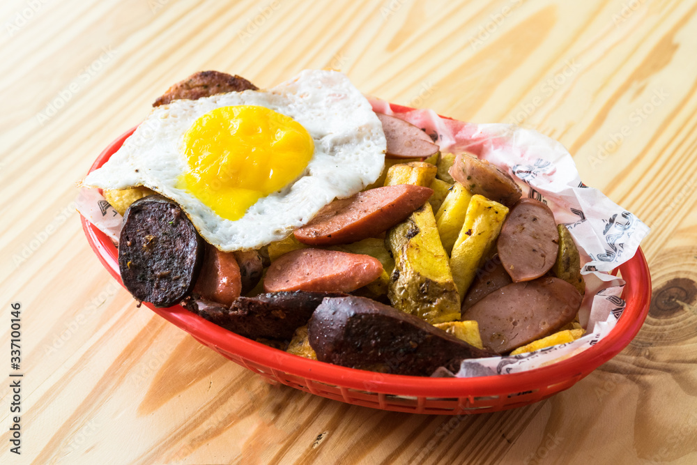 Peruvian salchipapa: hot dog with fried egg and potatoes Stock Photo ...
