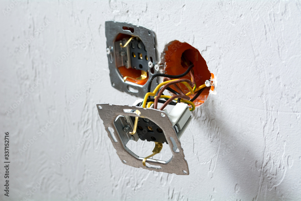 Socket plug installation. Disassembled electrical outlet with bare ...