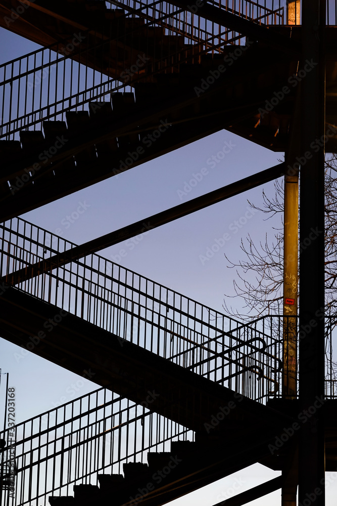Stockholm, Sweden Stairs in silhouette under the Liljeholmen bridge ...