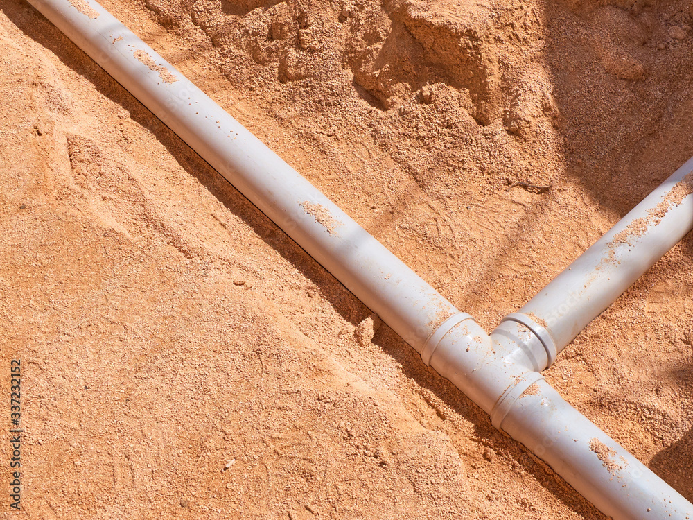 Junction of plastic sewer pipes. Sewage pipeline system of residential ...