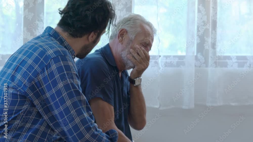4K Handsome adult Caucasian man comforting his depressed senior father ...