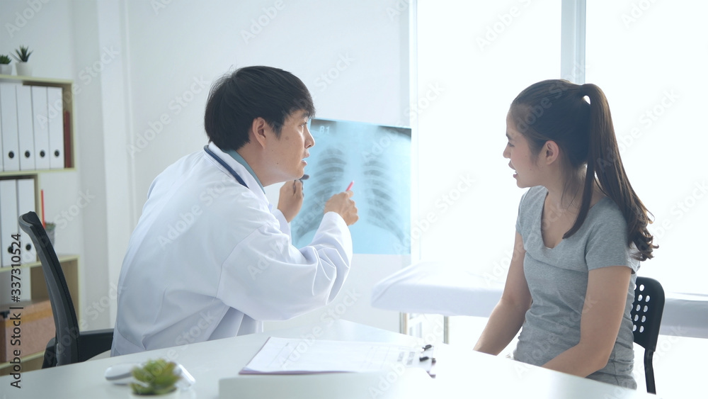 Medical concepts. The doctor is explaining the x-ray to the patient in ...