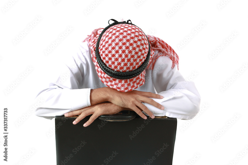 Arab man portrait wearing keffiyeh taking a nap with a black briefcase ...
