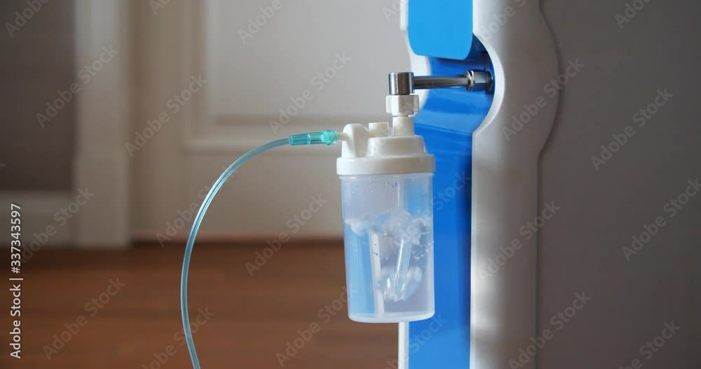 Oxygen passes through distilled water in O2 concentrator to oxygen mask ...