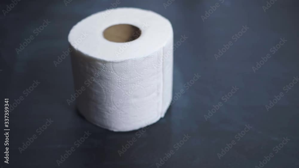 A roll of toilet paper slowly falls onto the table. Toilet paper ...