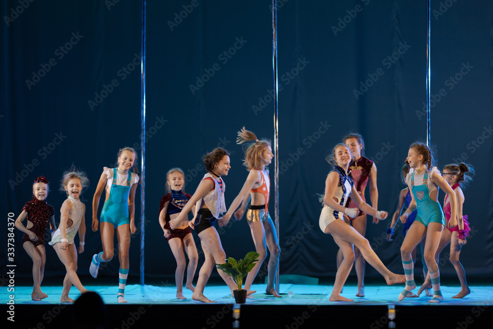 Girls gymnasts show the dance and performance on stage in the theater ...