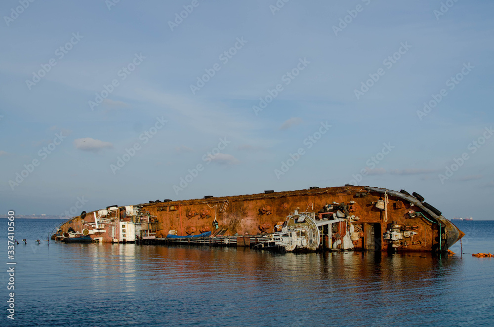 Cargo ship run aground on rocky shore. Shipwreck at sea. Ecological ...
