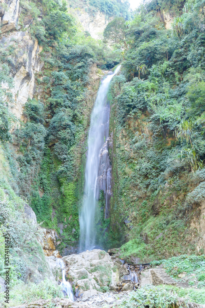 A tall waterfall in Himalayas, along Annapurna Circuit Trek in Nepal ...