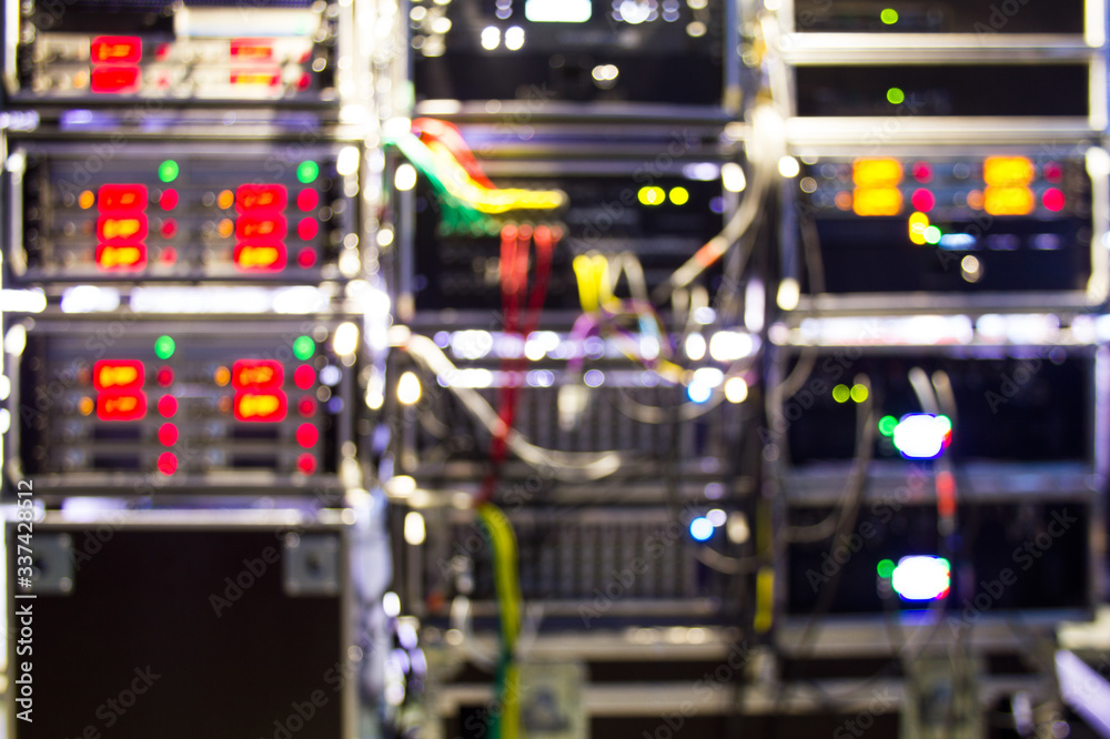 Blurred background of backstage area and tech zone with rack amplifiers ...