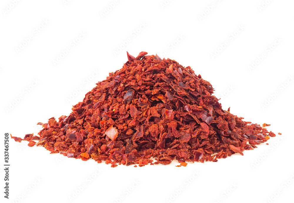 Heap of red pepper flakes isolated on a white background. Pile crushed ...