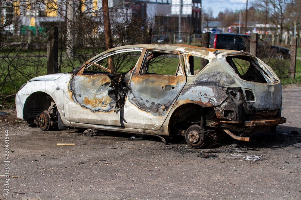 Burned car, burned-out car body. Road wreck accident or arson fire ...