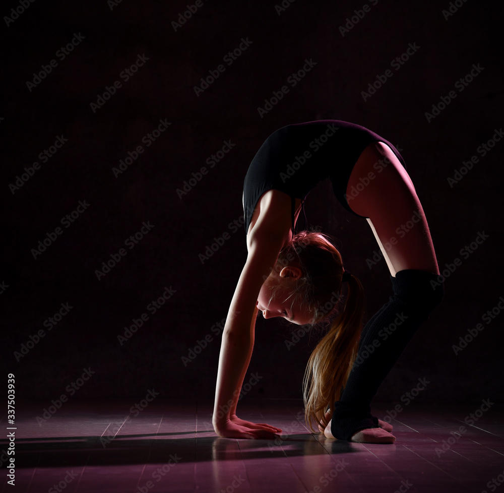 Young girl gymnast in black sport body and special footwear standing in ...